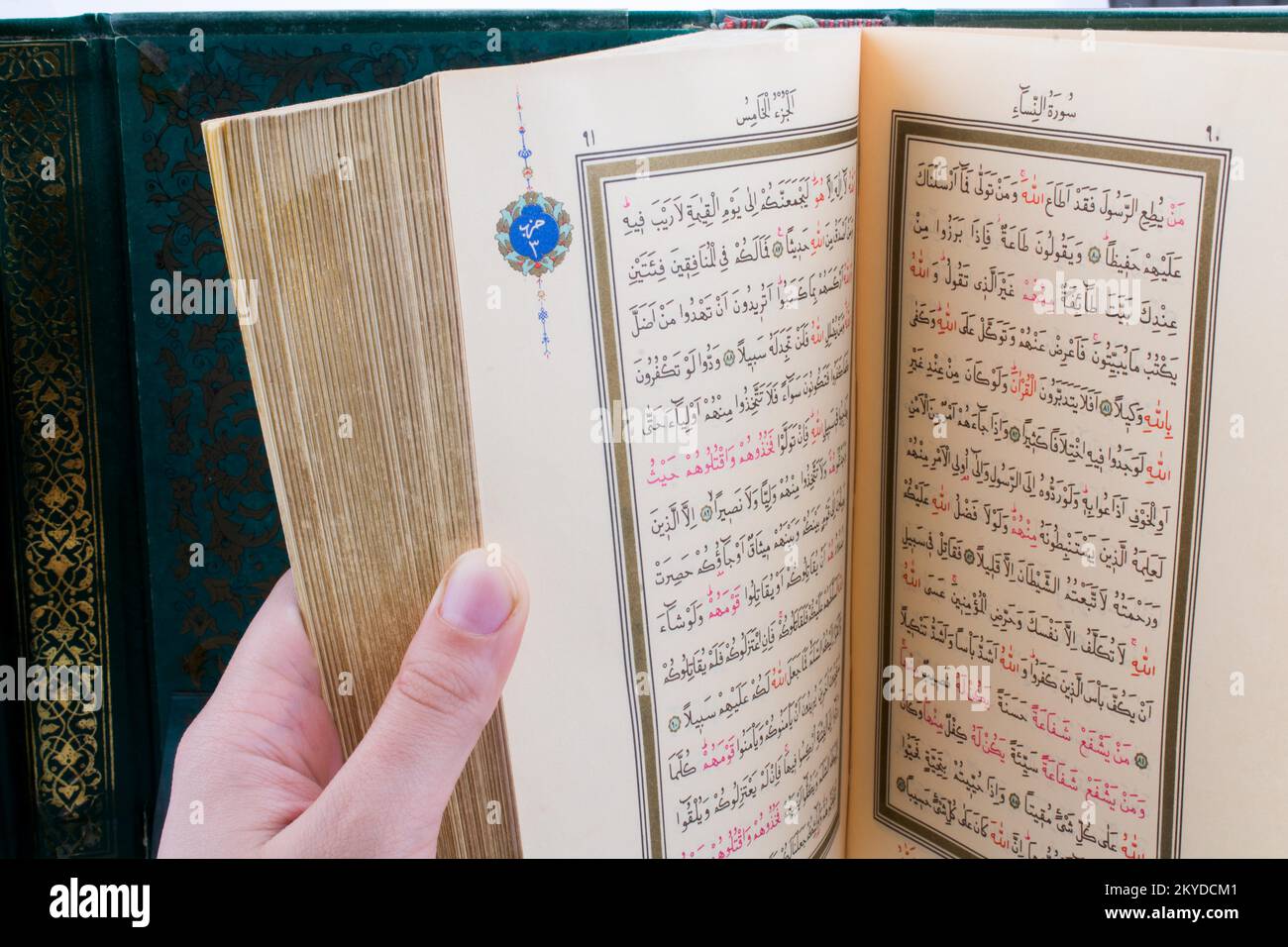 Hand holding The Holy Quran on a white background Stock Photo - Alamy