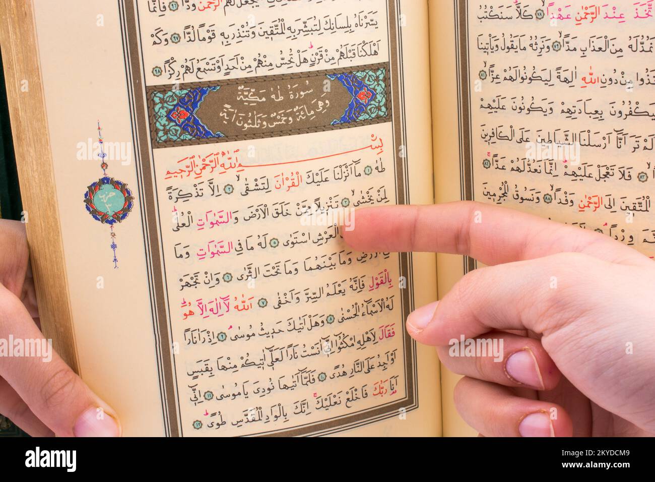 Hand holding The Holy Quran on a white background Stock Photo - Alamy