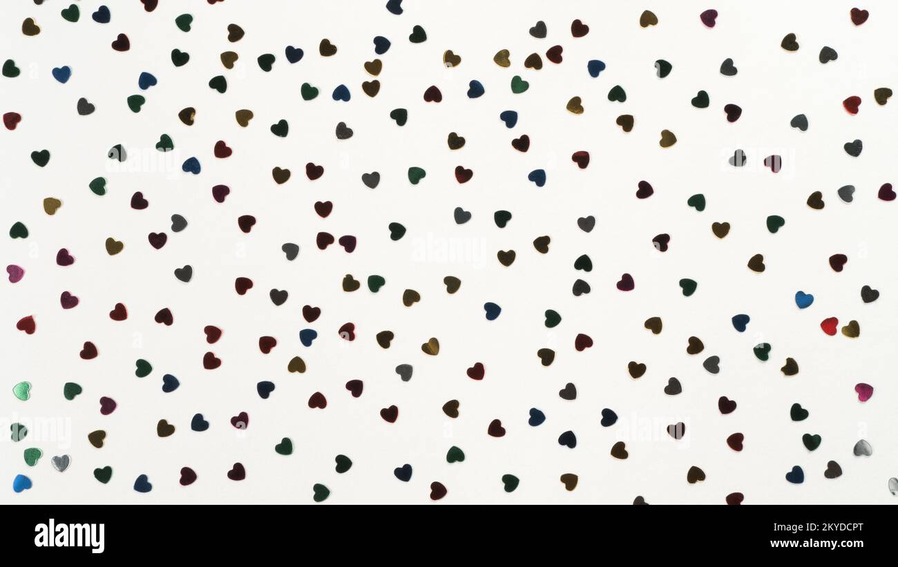 Small colorful paper foil hearts on white background. Decorative foil ...