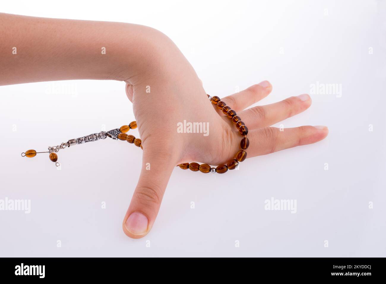 Hand holding a tespih on a white background Stock Photo - Alamy