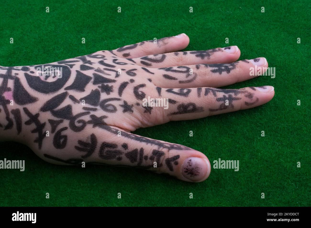 Hand with tattoo on green grass Stock Photo - Alamy