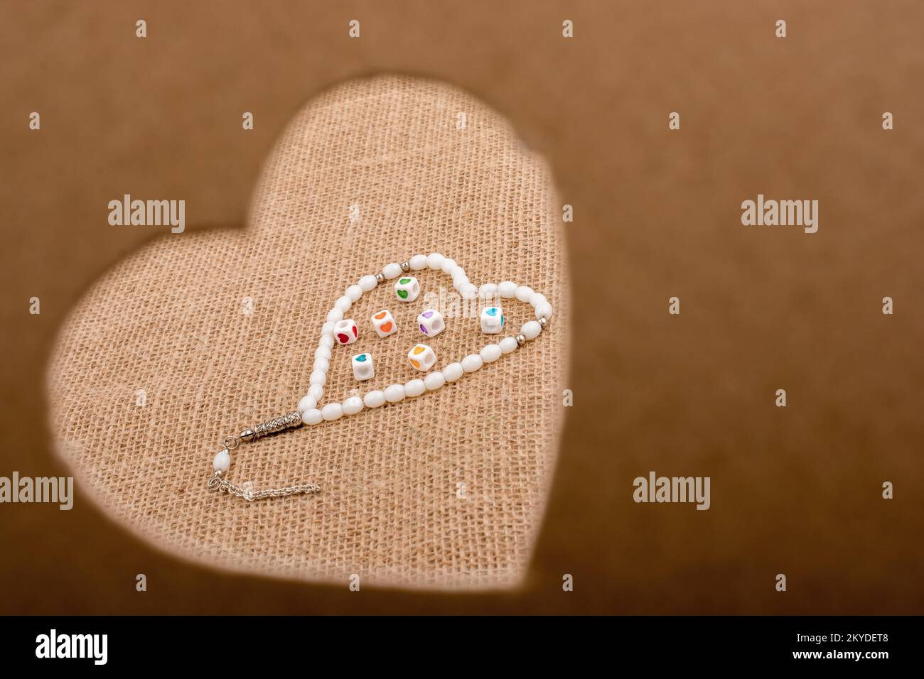 Heart shaped gold color metal object in hand Stock Photo - Alamy