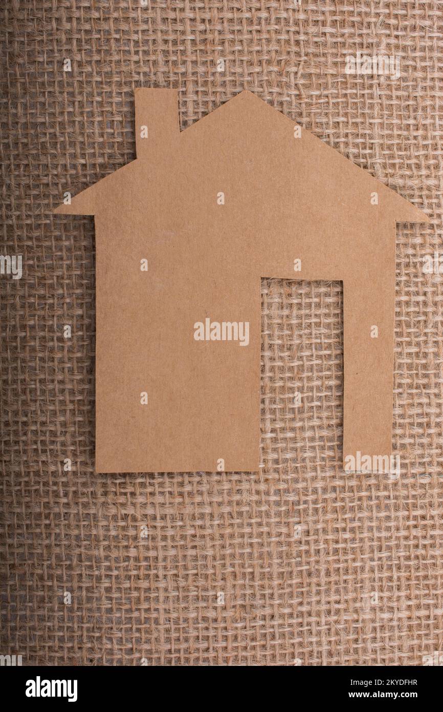 Little paper house placed on a linen canvas Stock Photo - Alamy