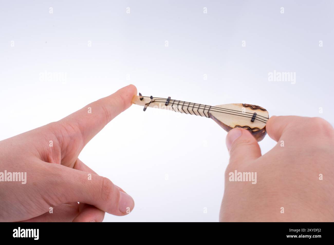 Hand holding turkish musical instrument saz on a white background Stock ...