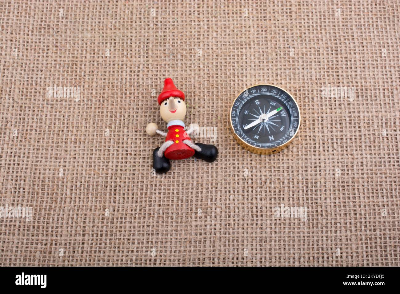 Figurine of pinocchio by the side of a compass Stock Photo - Alamy
