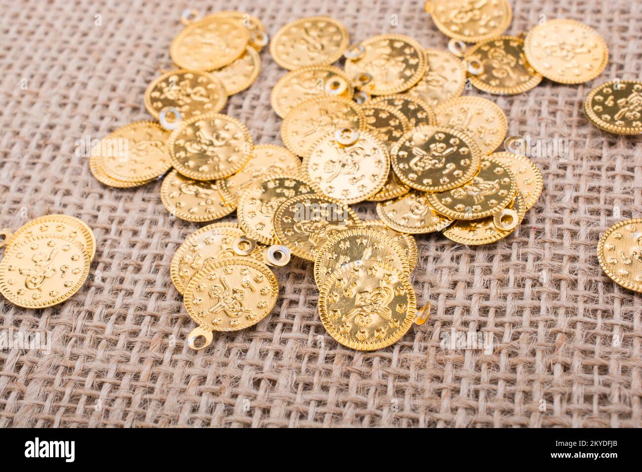 Plenty of fake gold coins are on canvas Stock Photo - Alamy