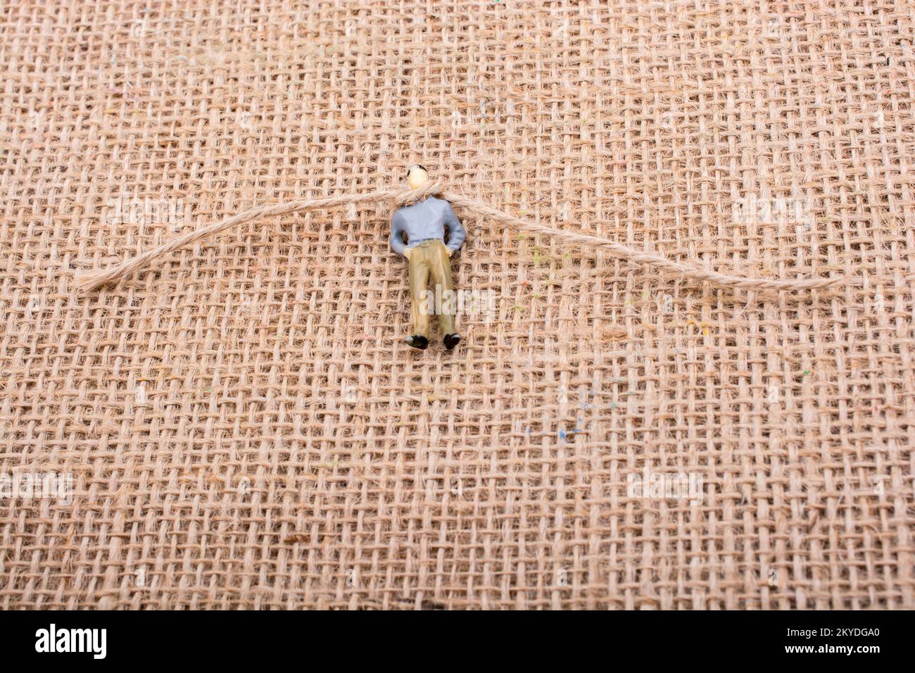 Figurine man with a rope on the neck Stock Photo - Alamy