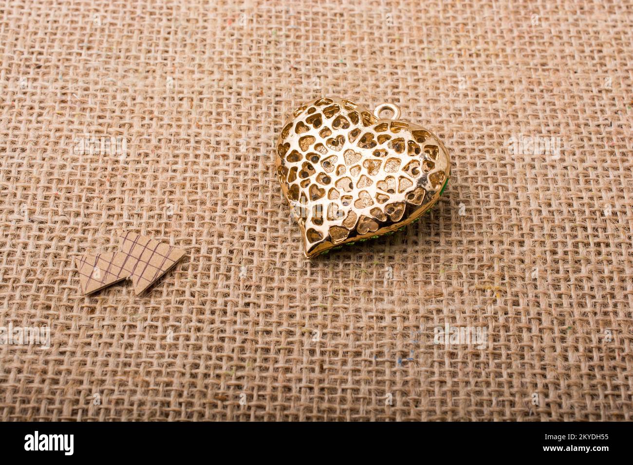 Heart shaped object with an arrow on canvas Stock Photo - Alamy