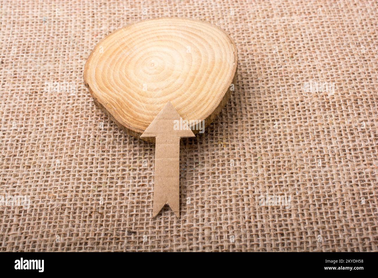 Arrow sign cut out of brown paper on piece of wood Stock Photo - Alamy