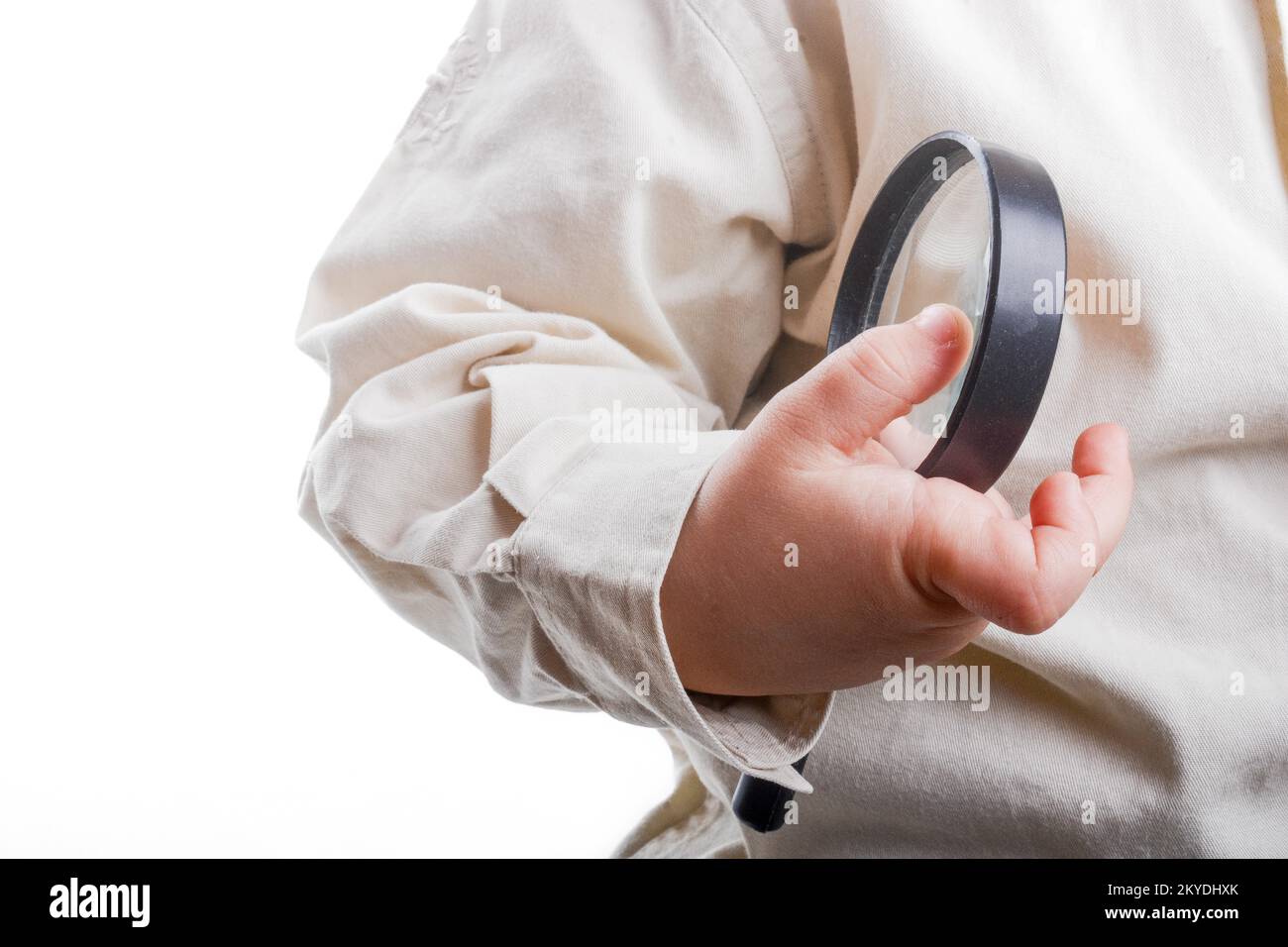 Baby holding a magnifying glass in hand on a white background Stock ...