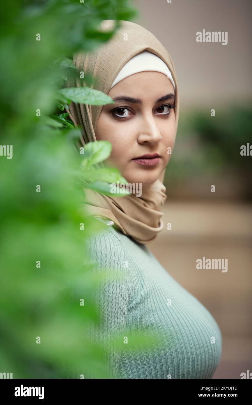 Beautiful muslim woman looking at camera outdoors Stock Photo - Alamy
