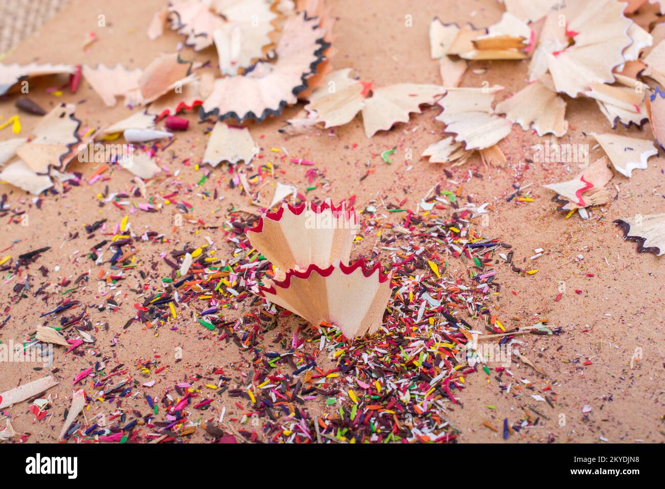 Colorful pencil shavings on a brown background Stock Photo - Alamy