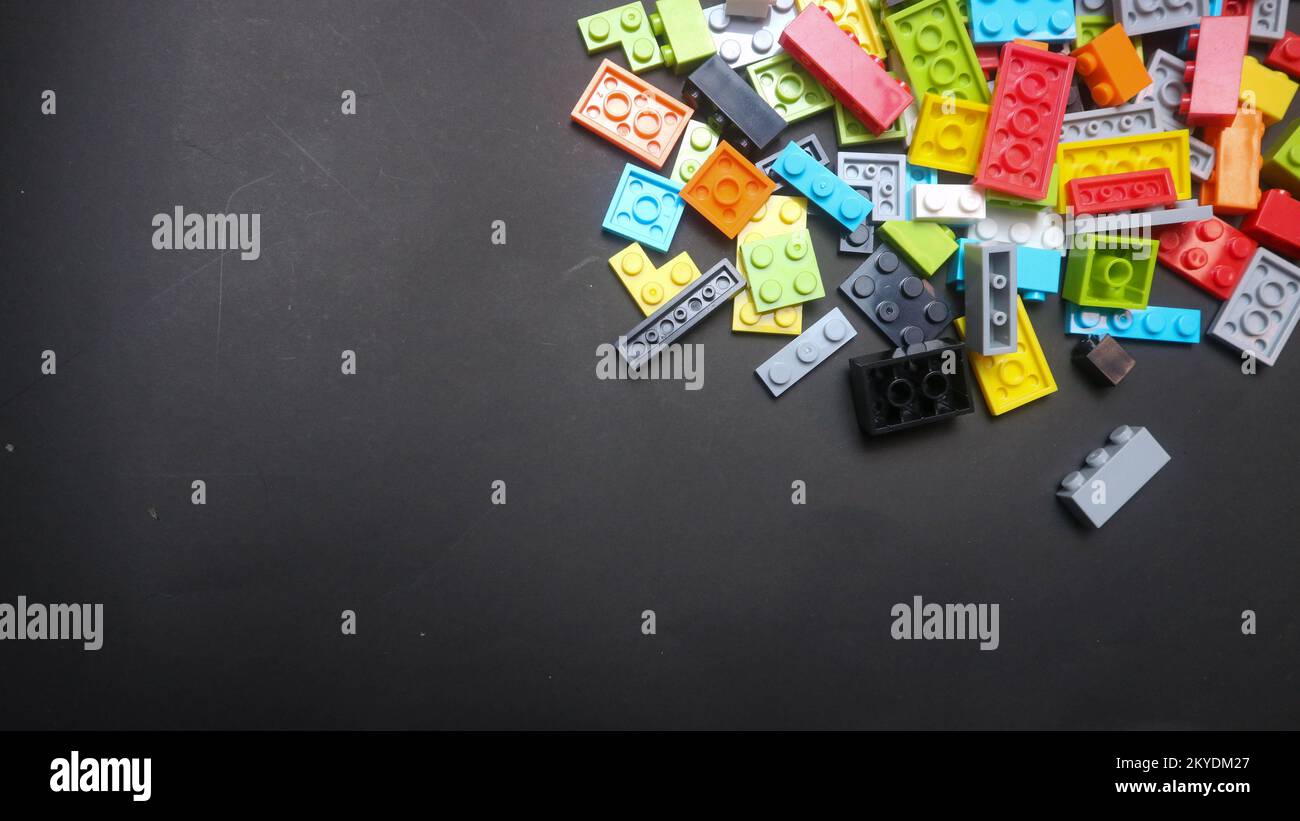 Plastic toy blocks on black background Stock Photo - Alamy