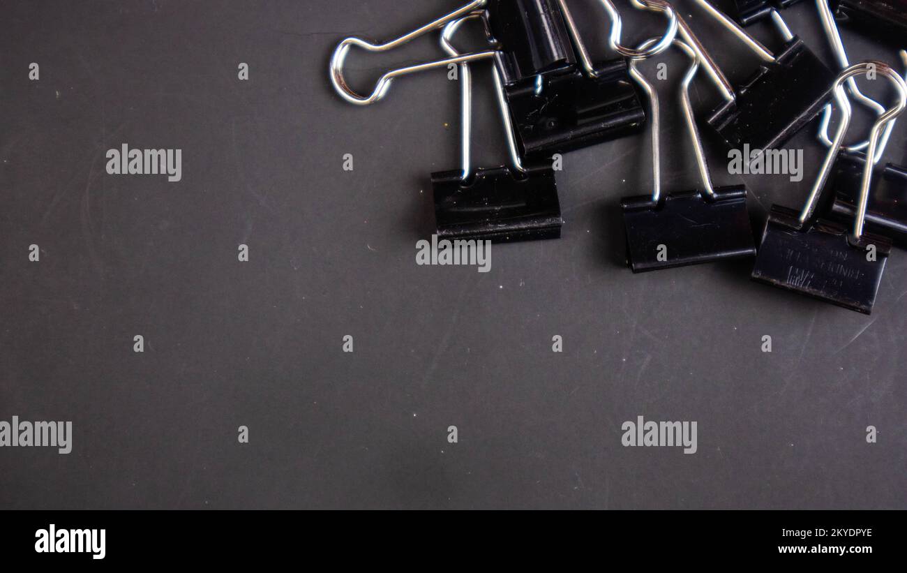 black paper clip on black background Stock Photo - Alamy