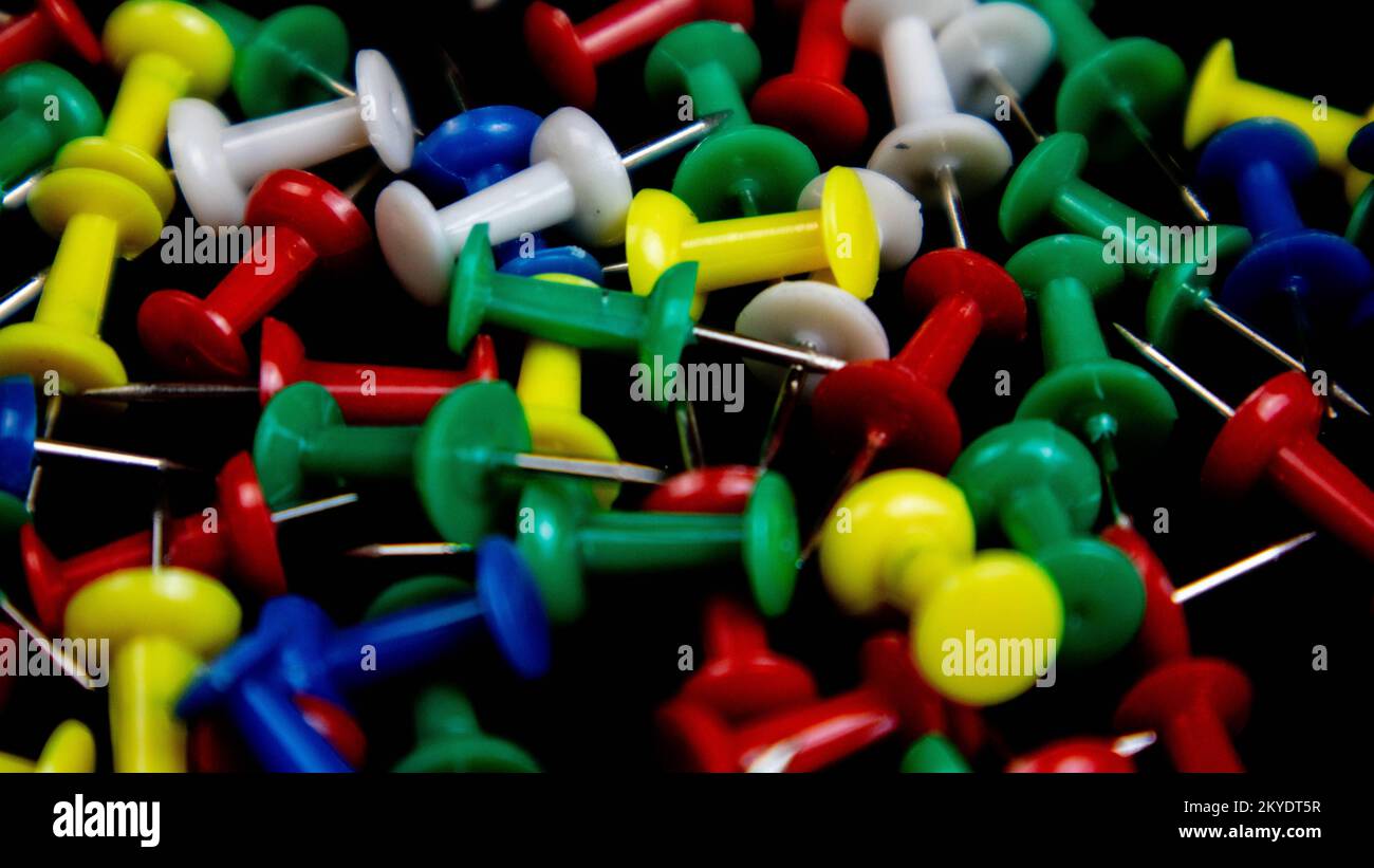colorful thumbtacks on black background Stock Photo - Alamy
