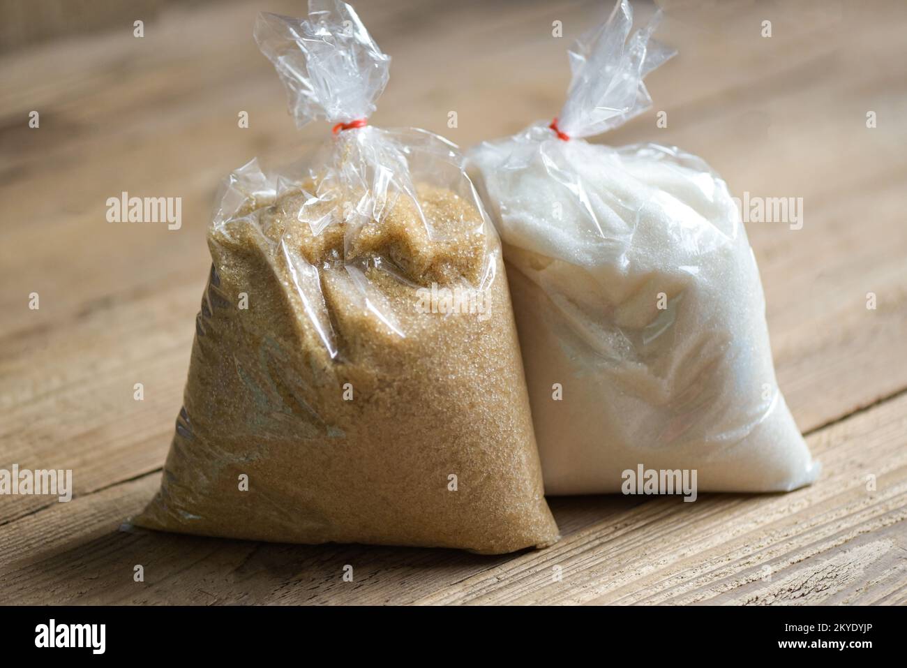 Sugar bag on wooden background, white and brown sugar for food and ...