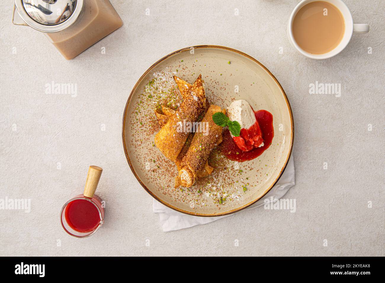 Sweet crepe roll with cream and jam Stock Photo - Alamy
