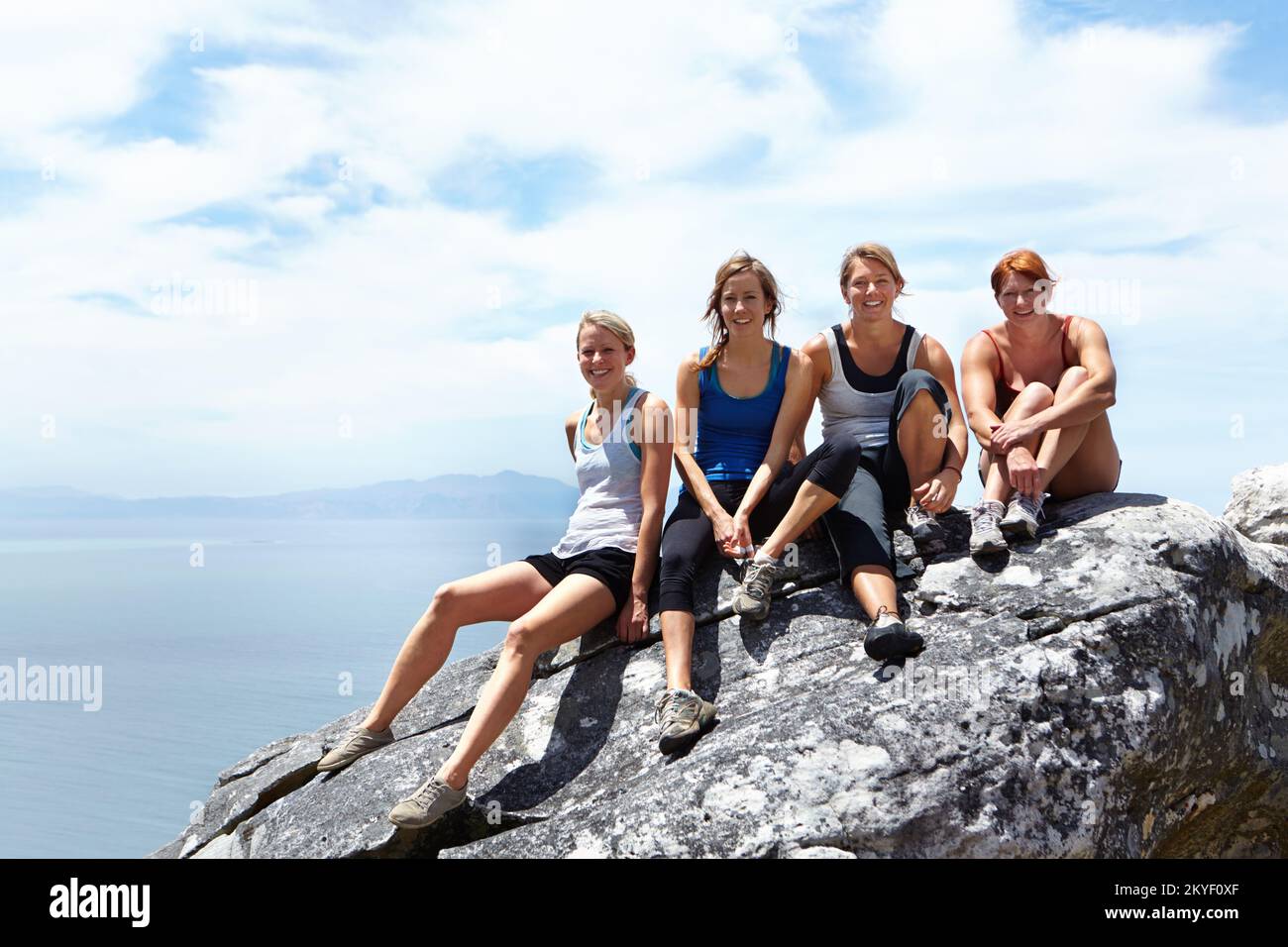 Getting to the top. a group of friends taking a break after reaching ...