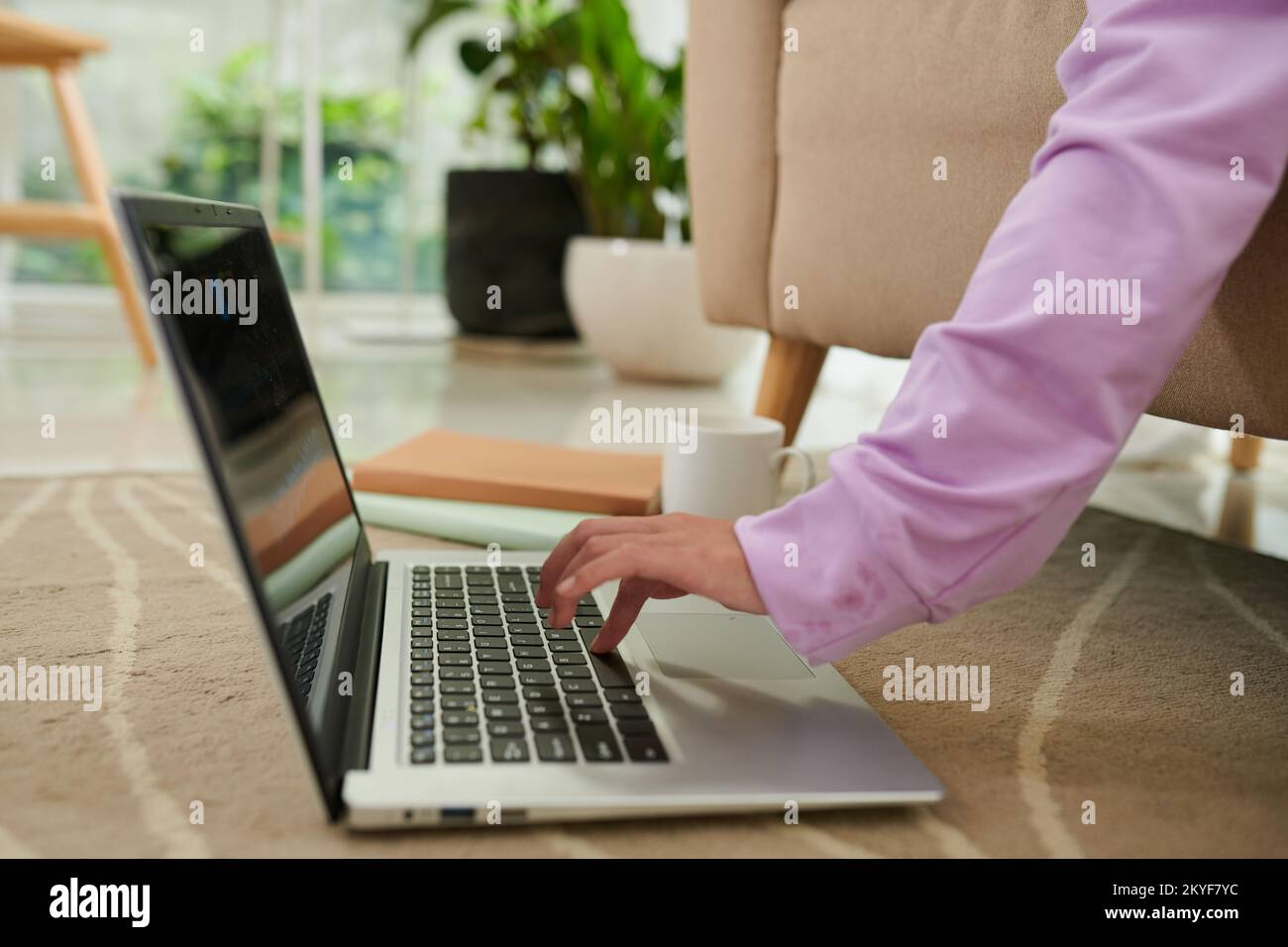 Hand of teenage girl pressing button on laptop to turn on music Stock ...