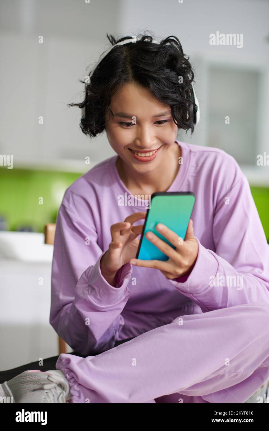 Smiling teenage girl answering text messages from friends Stock Photo ...
