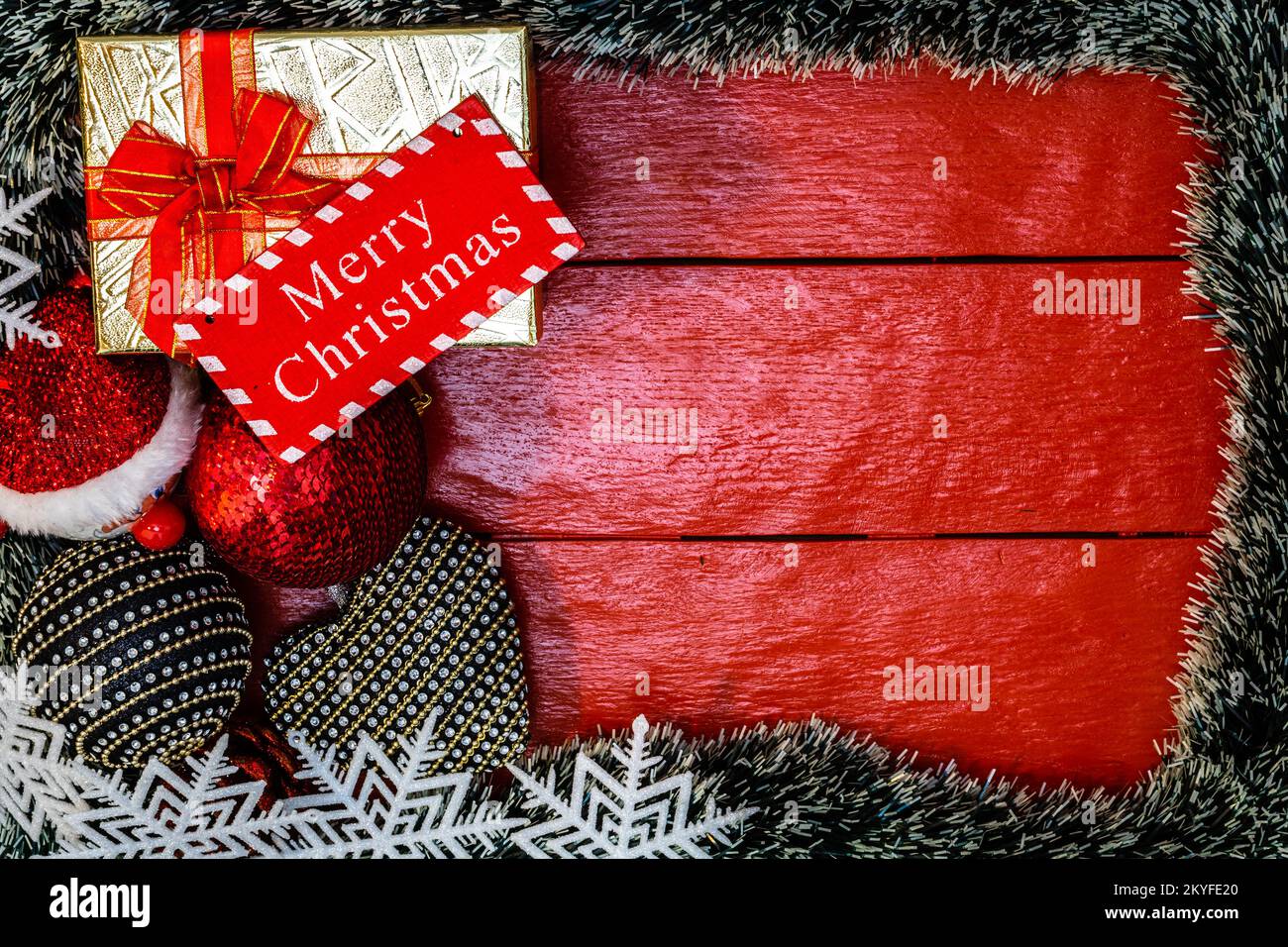 Christmas composition on red wooden board with Christmas garland and ...