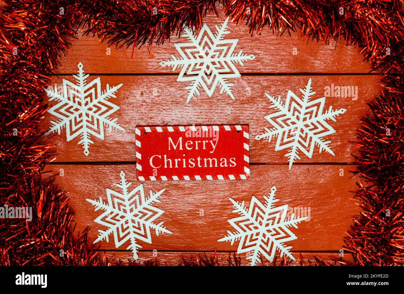 Christmas composition on red wooden board with Christmas garland and ...