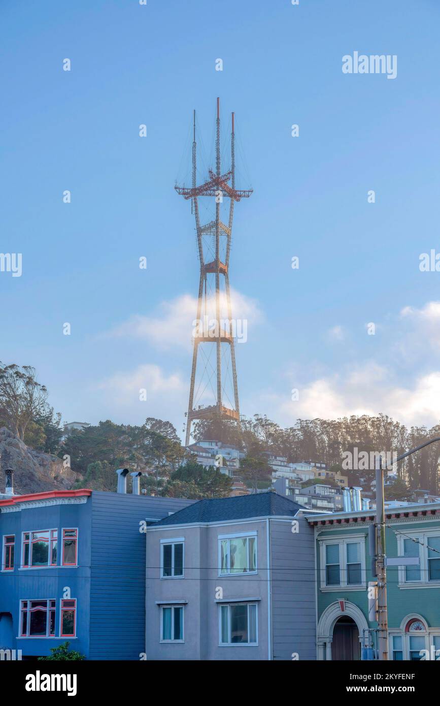 Sutro Tower with clouds against the sky above the townhouses in San ...
