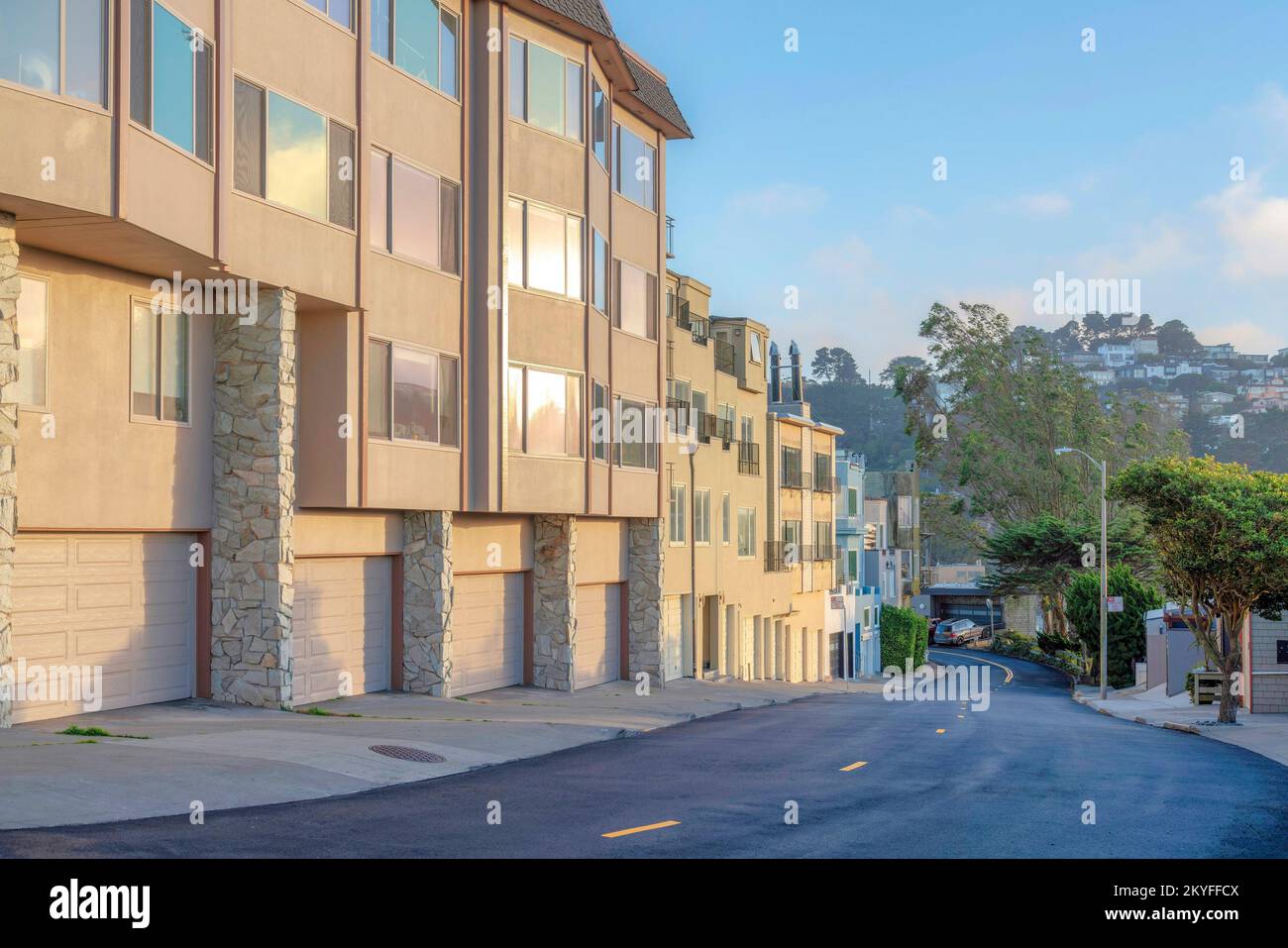 Roadside apartment buildings with attached garage and a view of ...