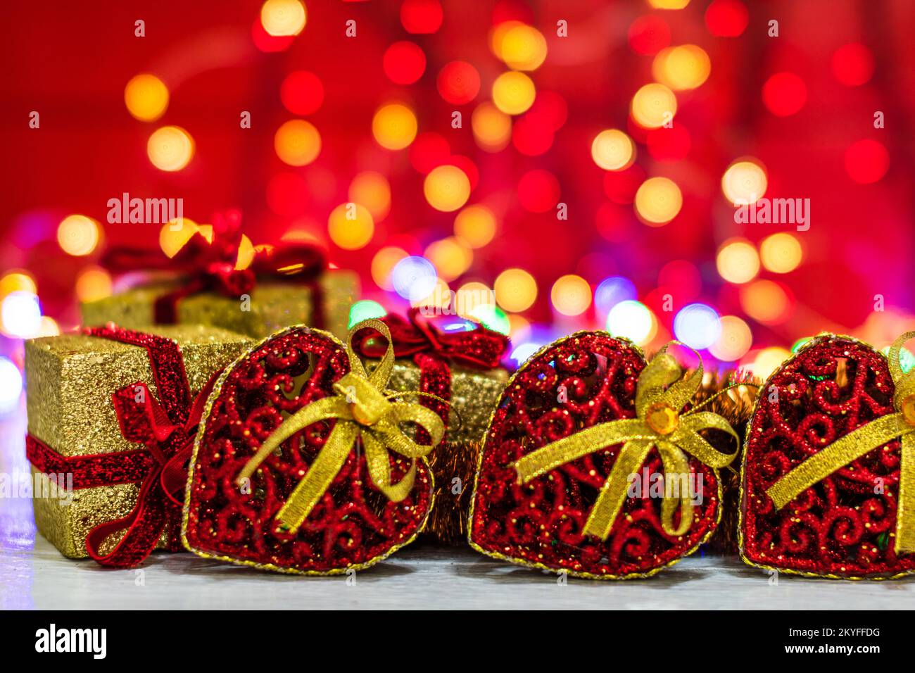 Glittery heart shaped Christmas balls and Christmas gifts. Christmas ...
