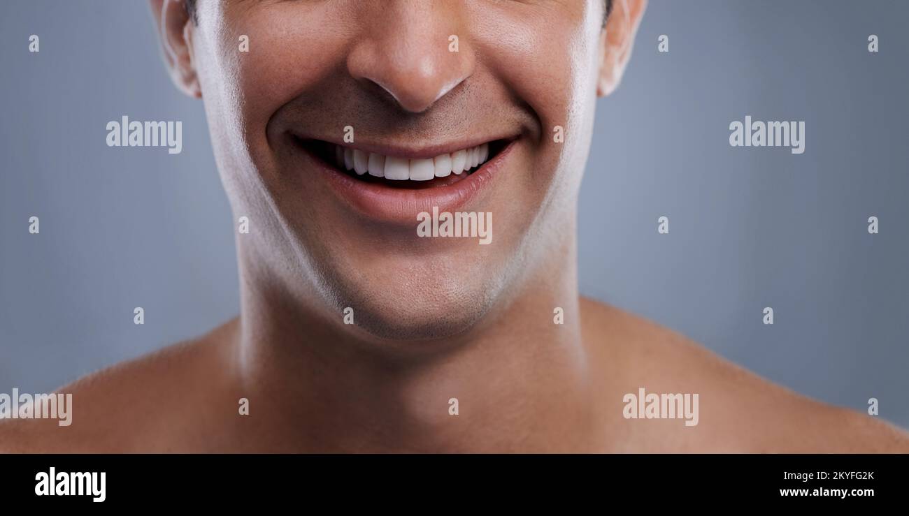 Clean shaven. Cropped studio shot of the lower half of a young mans ...