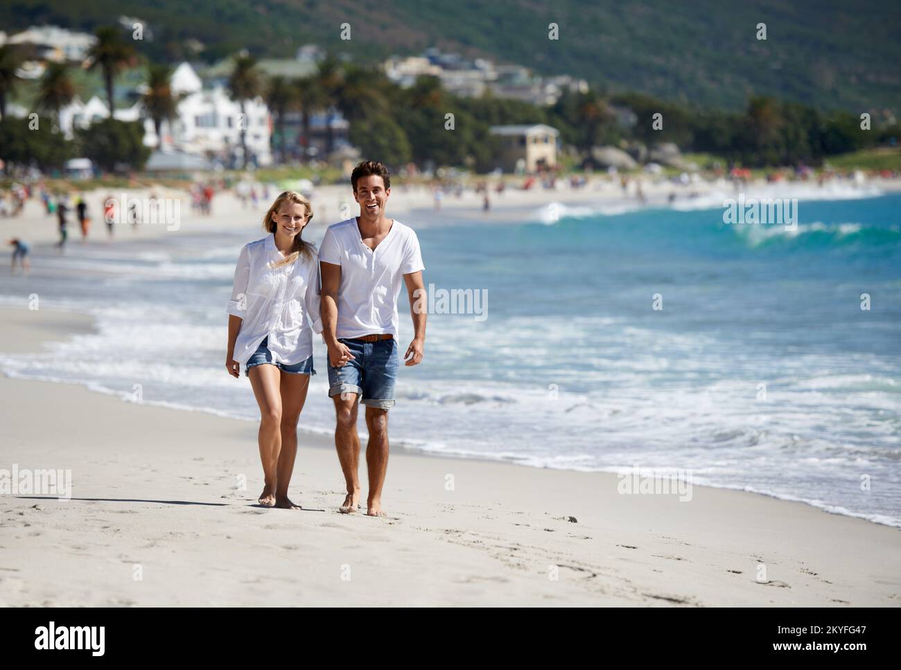 Romantic walk on the beach. A young couple walking on the beach Stock ...