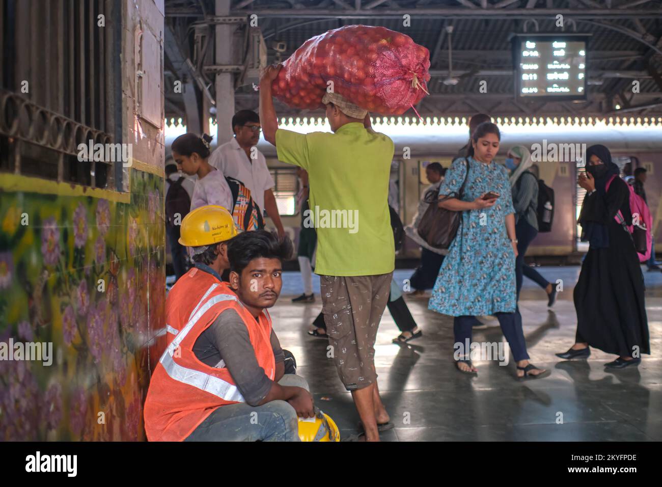 Construction workers sitting outside Byculla Station in Byculla, Mumbai ...
