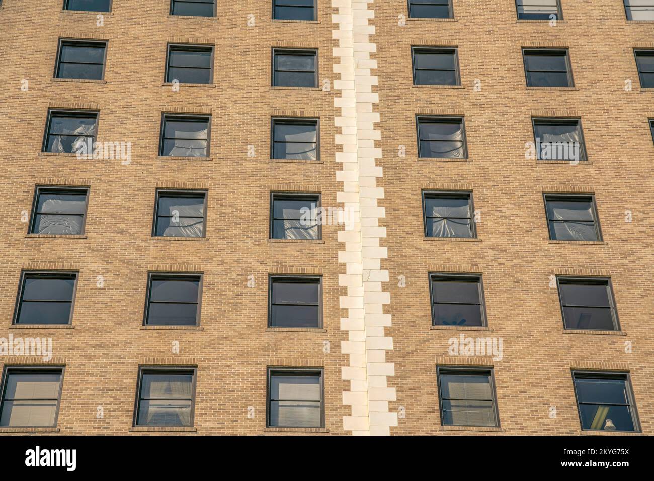 Exterior of residential building with square windows and brick wall ...