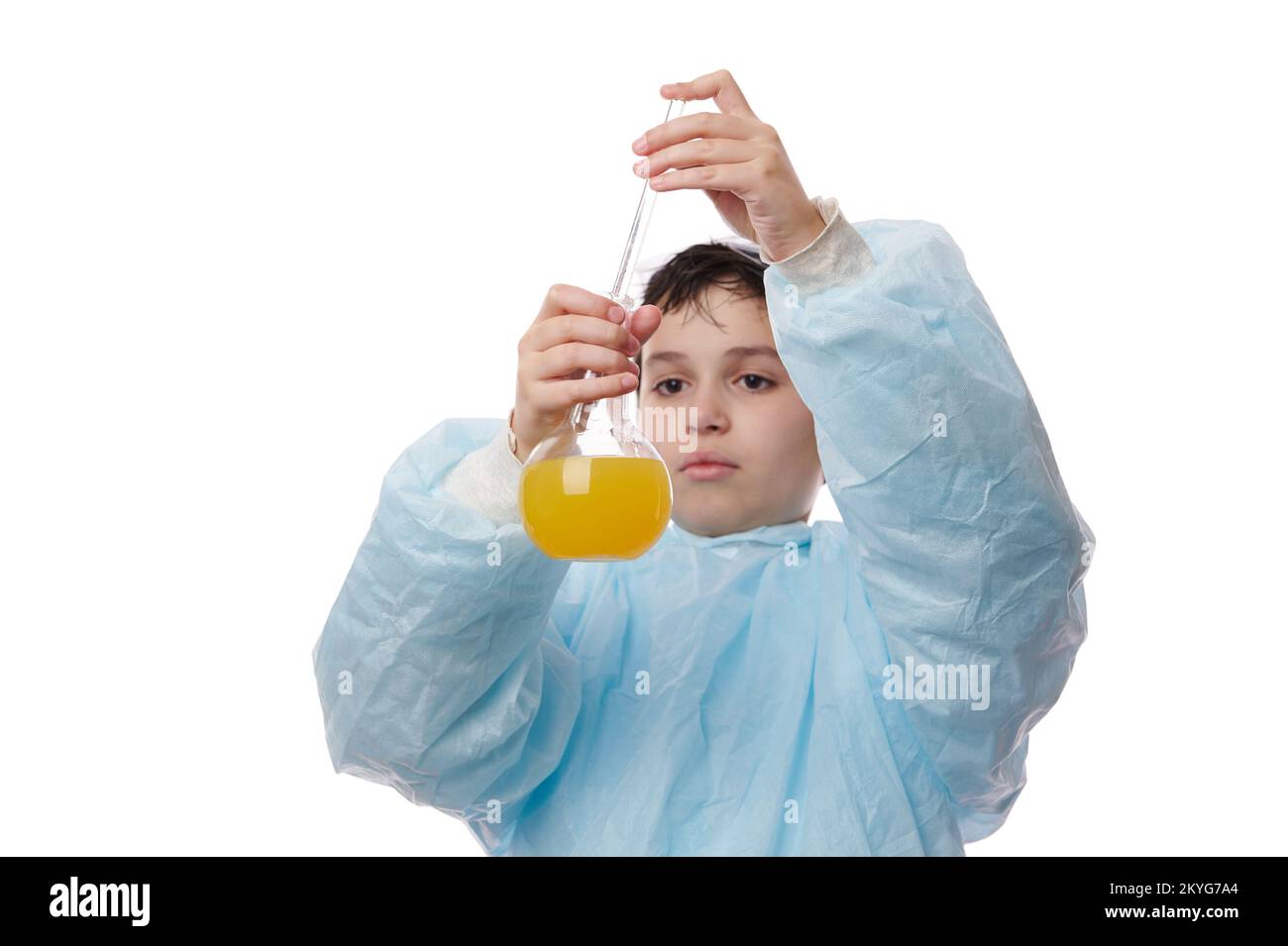 Smart teenage boy filling a pipette with chemical liquid from a lab ...