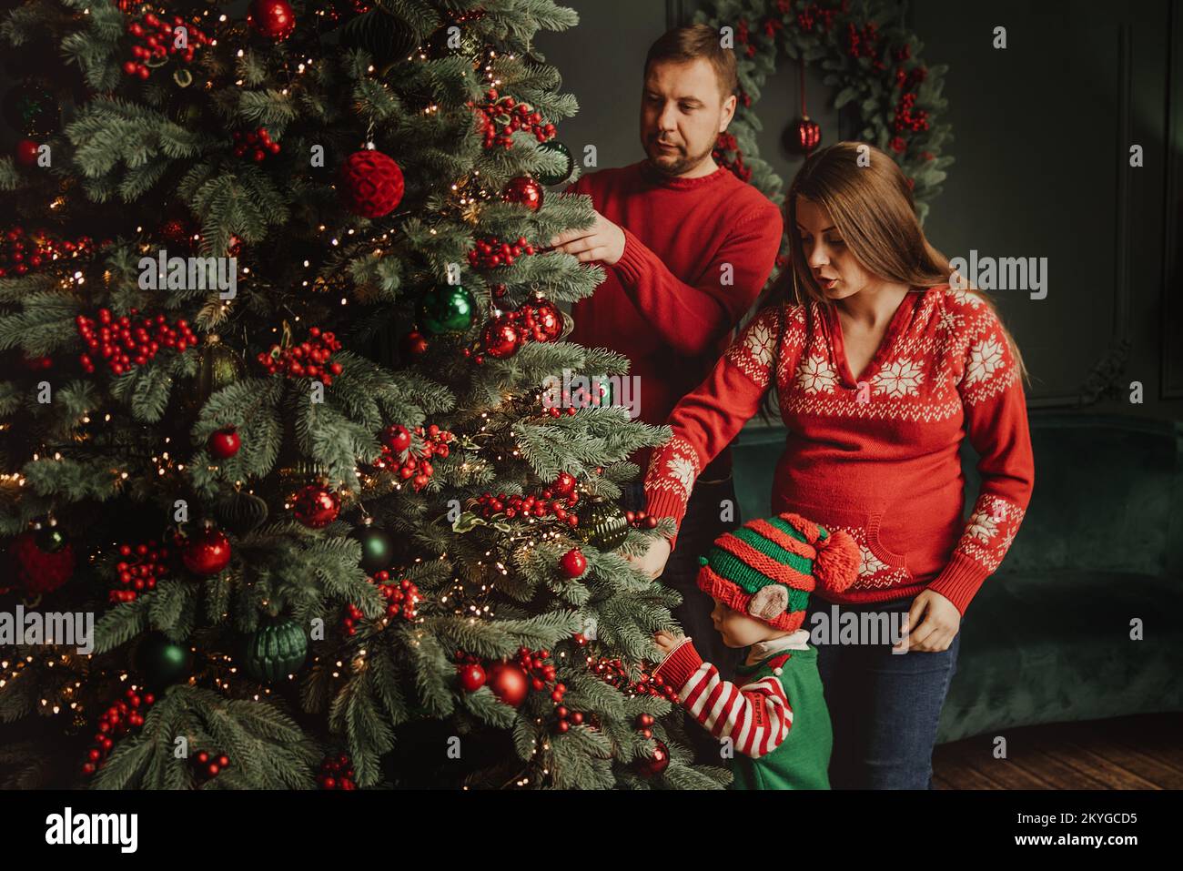 Happy family under Christmas tree. baby boy in Santa Claus hat with ...