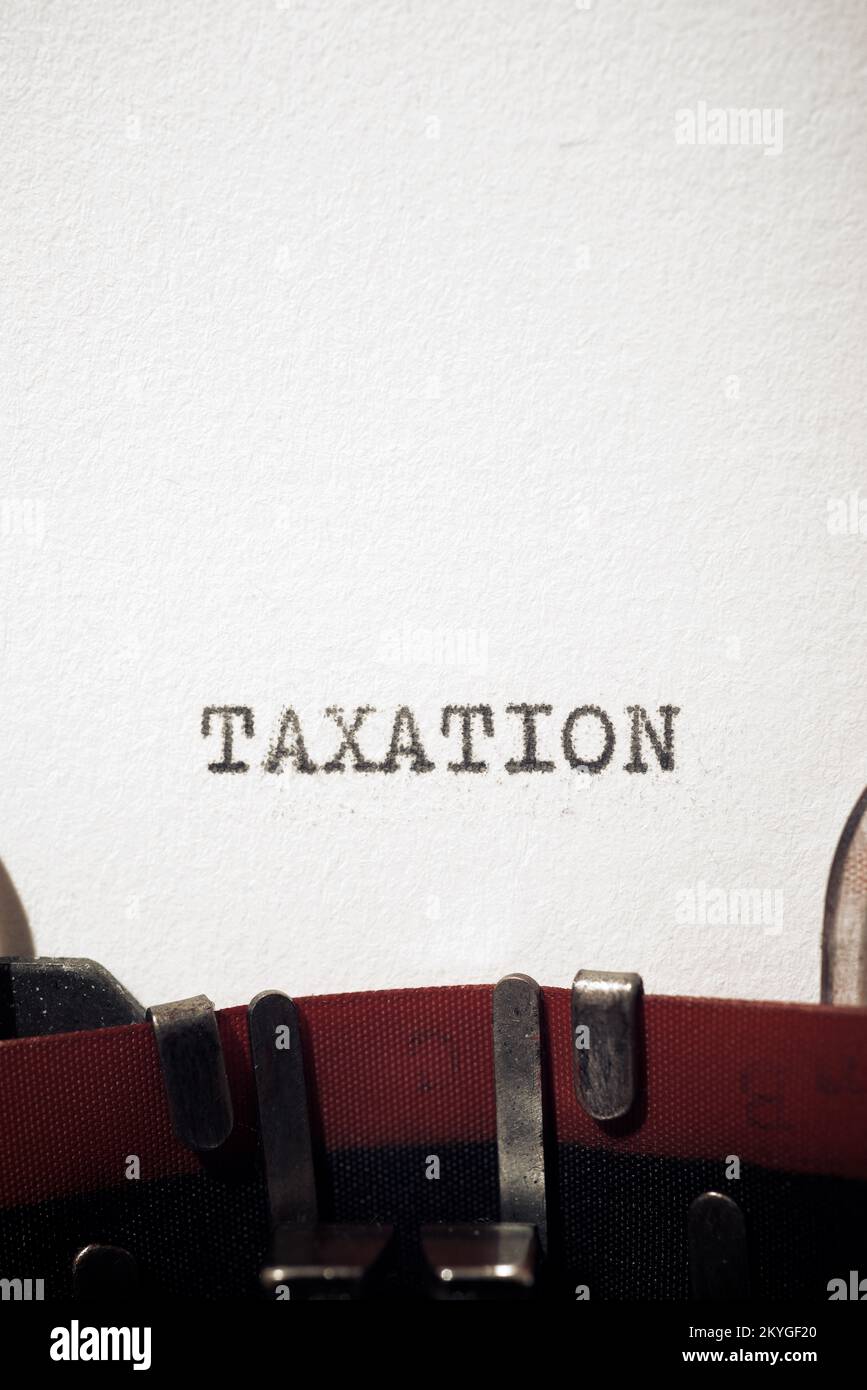 Taxation text written with a typewriter Stock Photo - Alamy