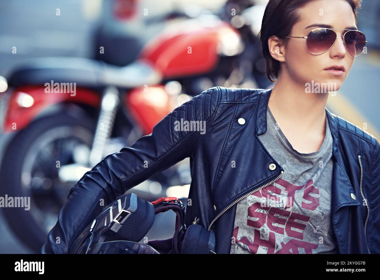 I make this bike look good. a young and stylish female motorcycle rider ...