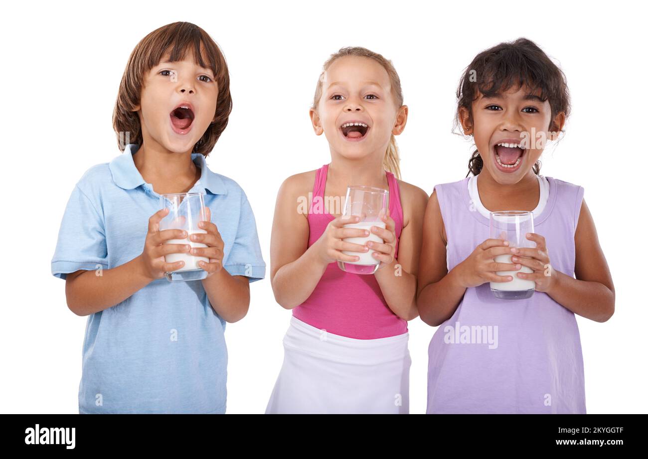 More milk. Studio shot of three young children laughing as they drink ...