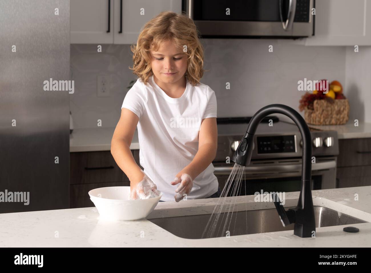 Child cleaning dishes with sponge. Cleaning supplies. Help clean-up ...