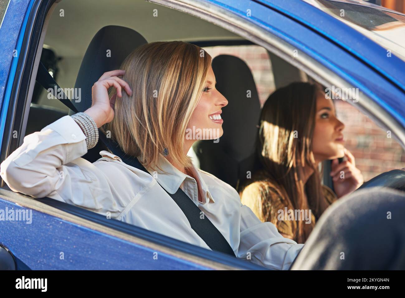 Girls day out. two young women traveling in a car in the city Stock ...