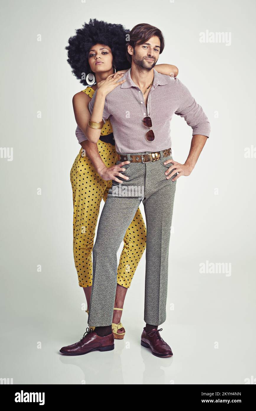 Retro couple. An attractive young couple standing together in retro 70s ...