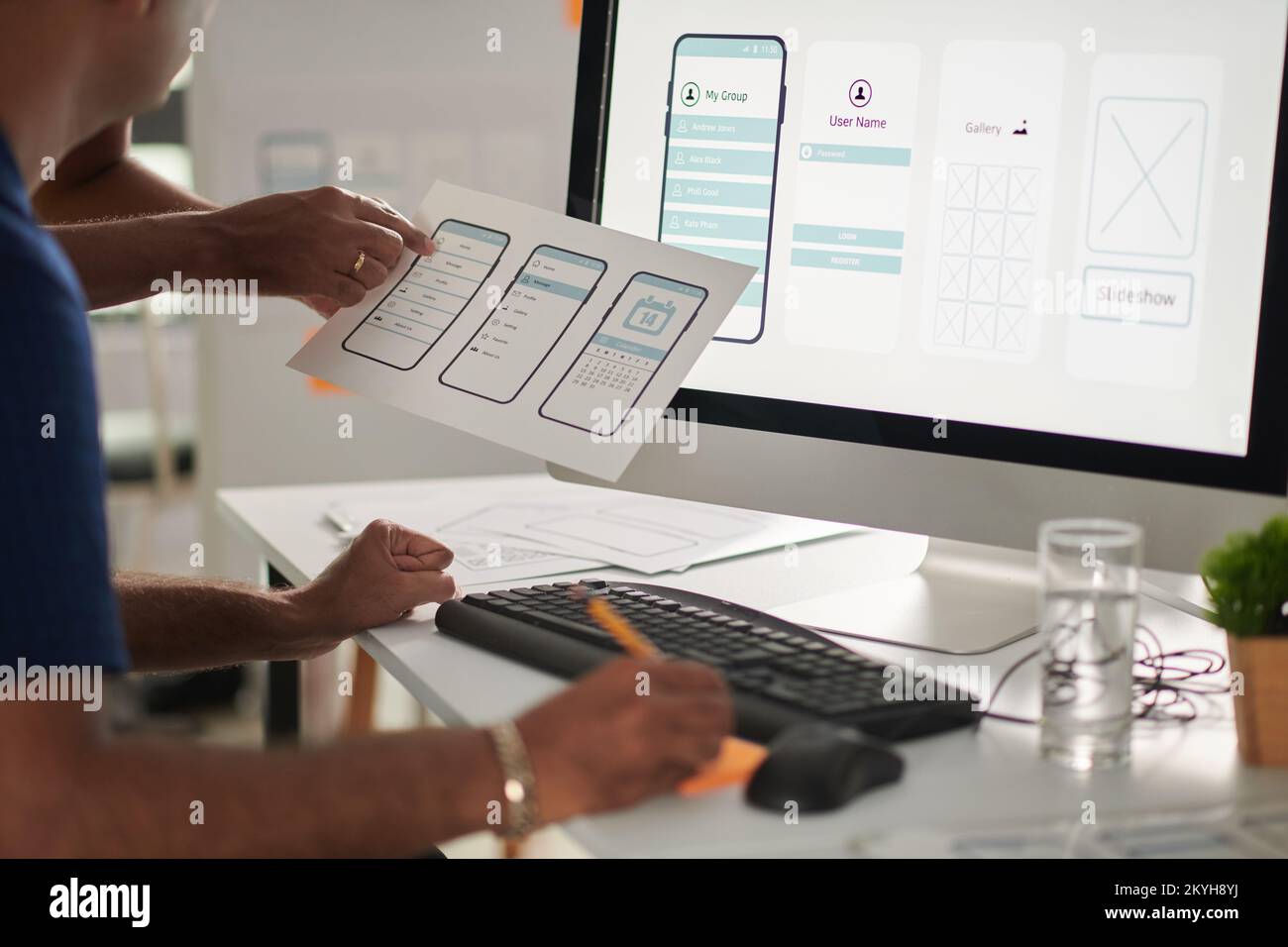 UX designer showing his ideas to colleagues working on new app ...