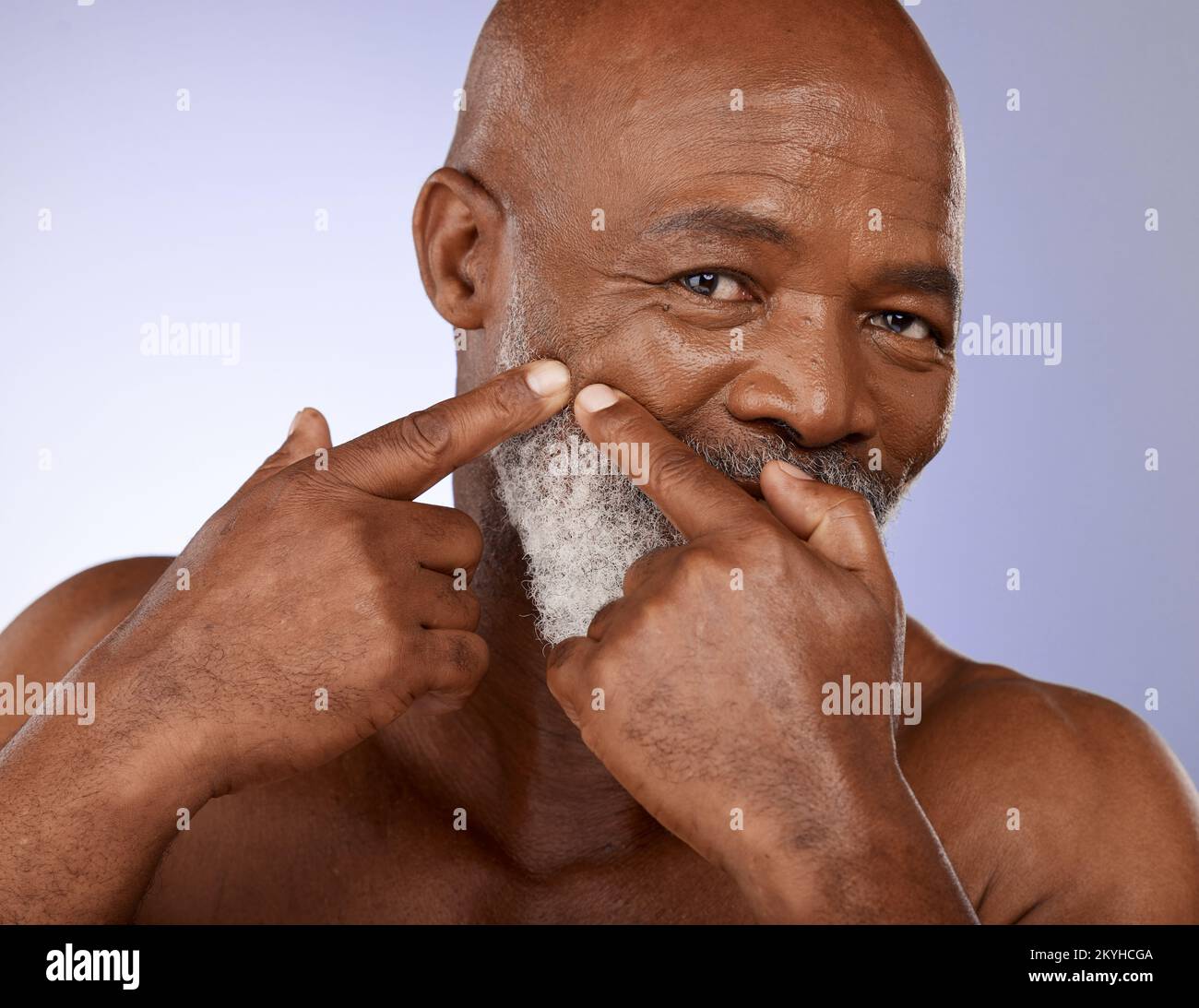 Face, beauty and skincare with a senior black man checking his skin for ...