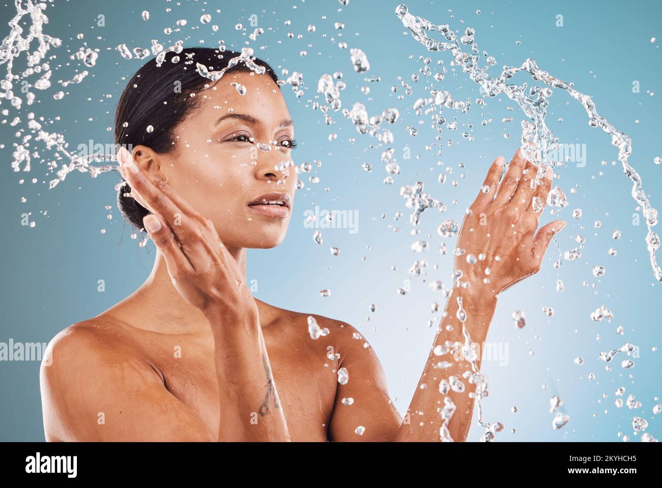 Beauty, skincare and black woman with splash of water for cleaning, hygiene and body care ...