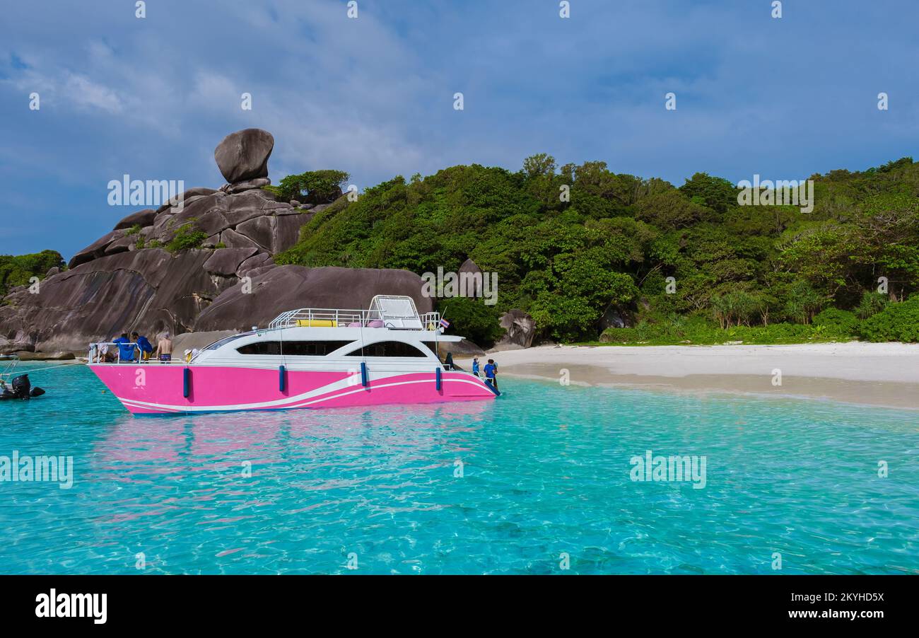 Tourist boat and Turqouse colored ocean and white beach at the tropical ...