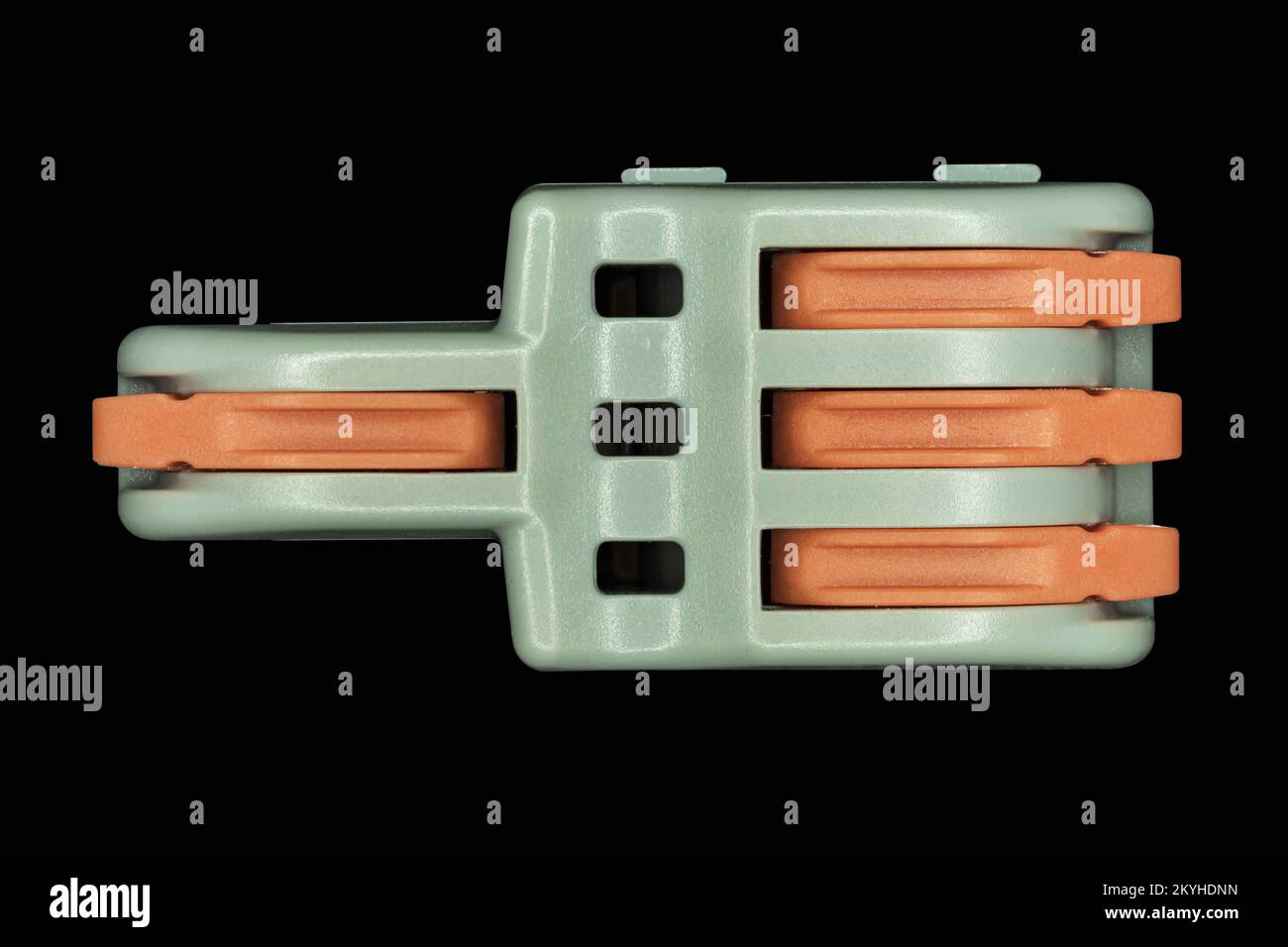Compact splicing connector isolated on black background. Close-up. A ...