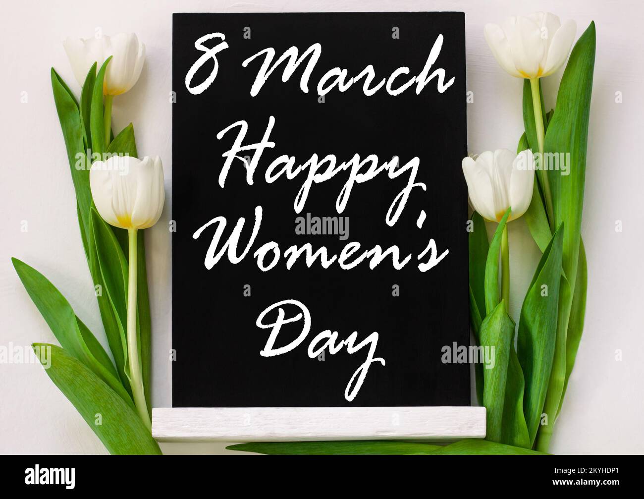 Happy Women's Day 8 March sign on black chalkboard with tulip flowers ...