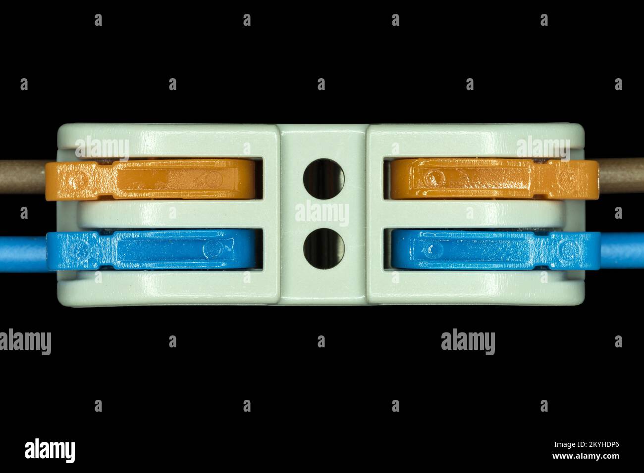 Compact splicing connector isolated on black background. Close-up. A ...