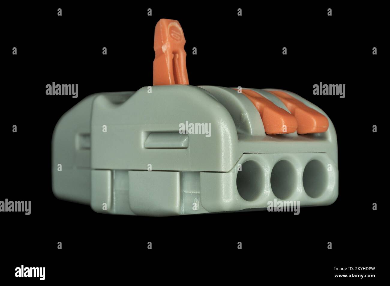Compact splicing connector isolated on black background. Close-up. A ...