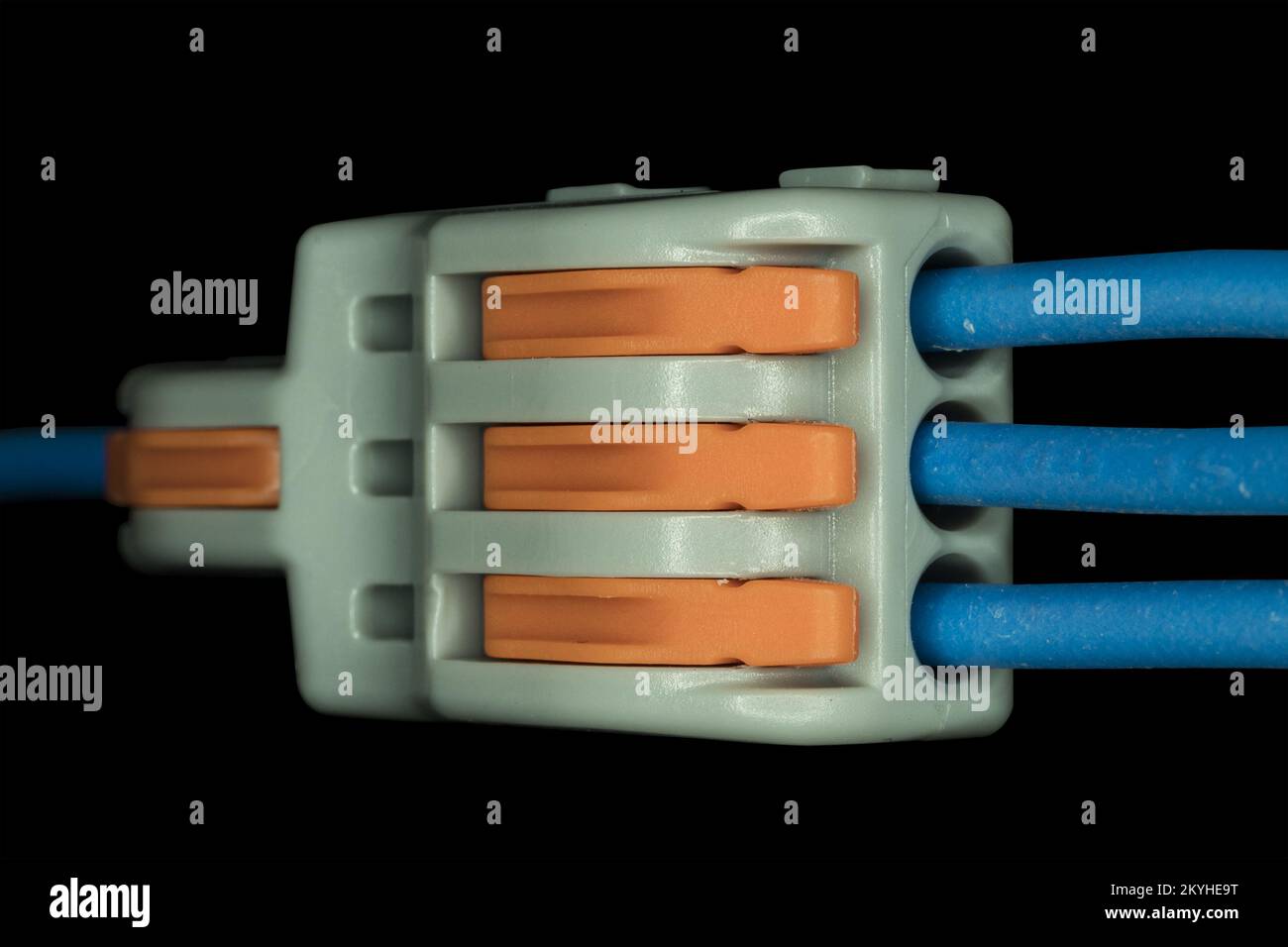 Compact splicing connector isolated on black background. Close-up. A ...